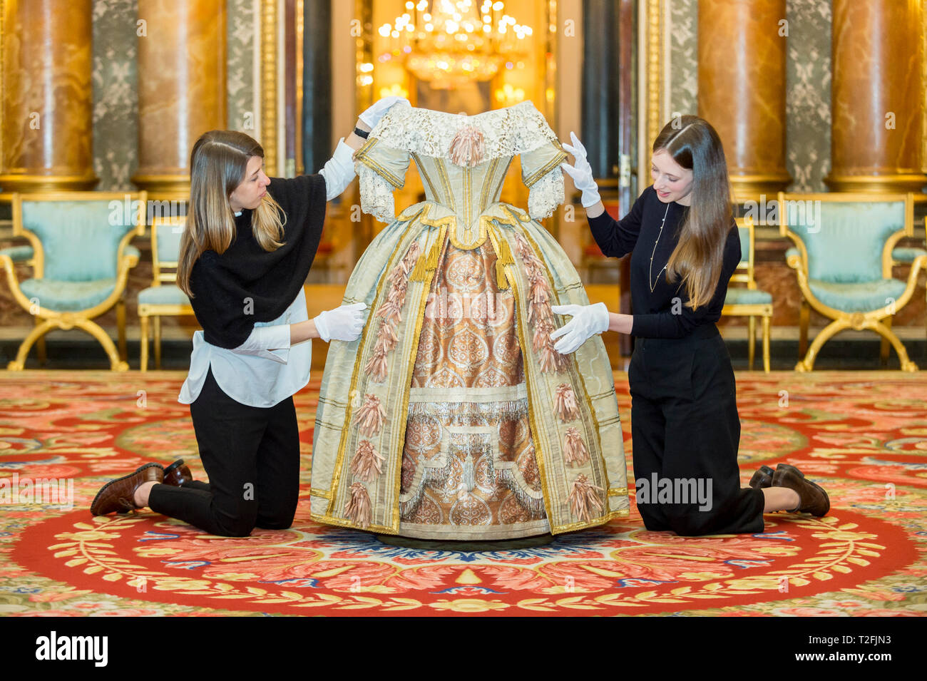 London, UK. 2 April 2019. Curators pose with Queen Victoria's Stuart ...