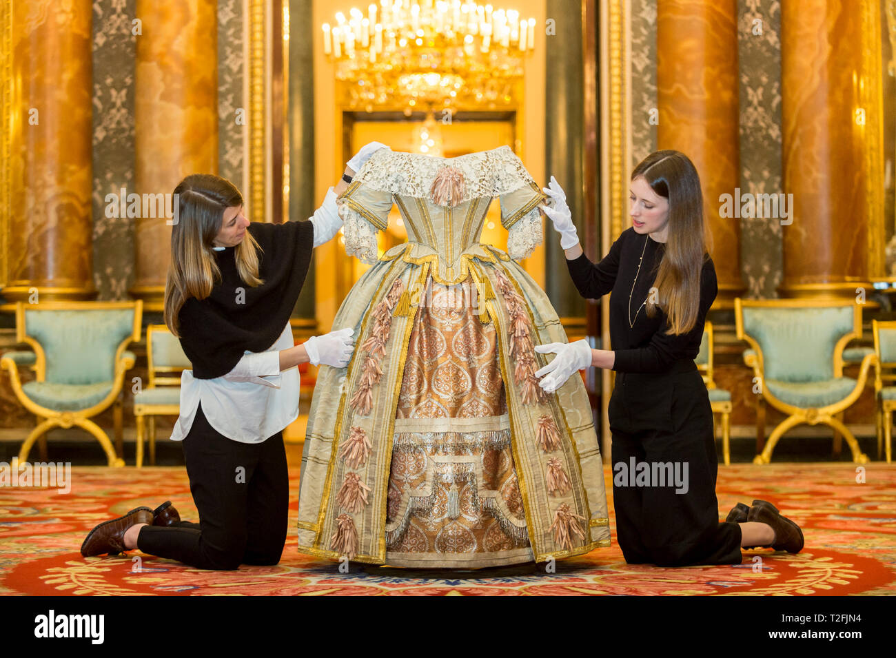 London, UK. 2 April 2019. Curators pose with Queen Victoria's Stuart ...