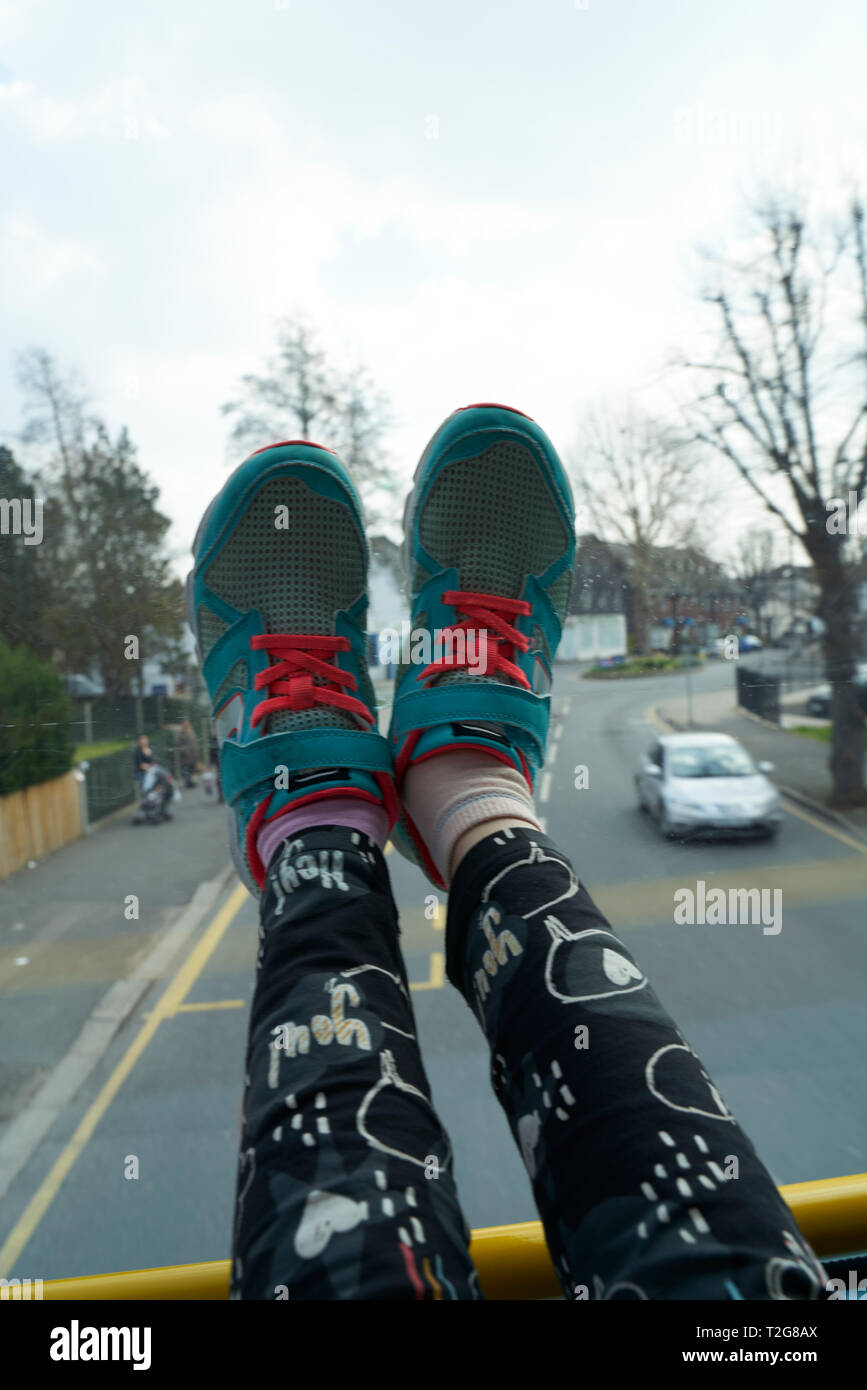 Feet on bus window Stock Photo - Alamy