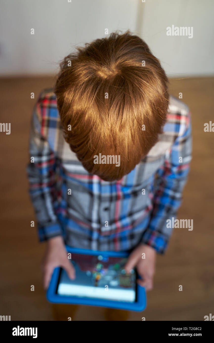 Boy playing tablet lonely hi-res stock photography and images - Alamy
