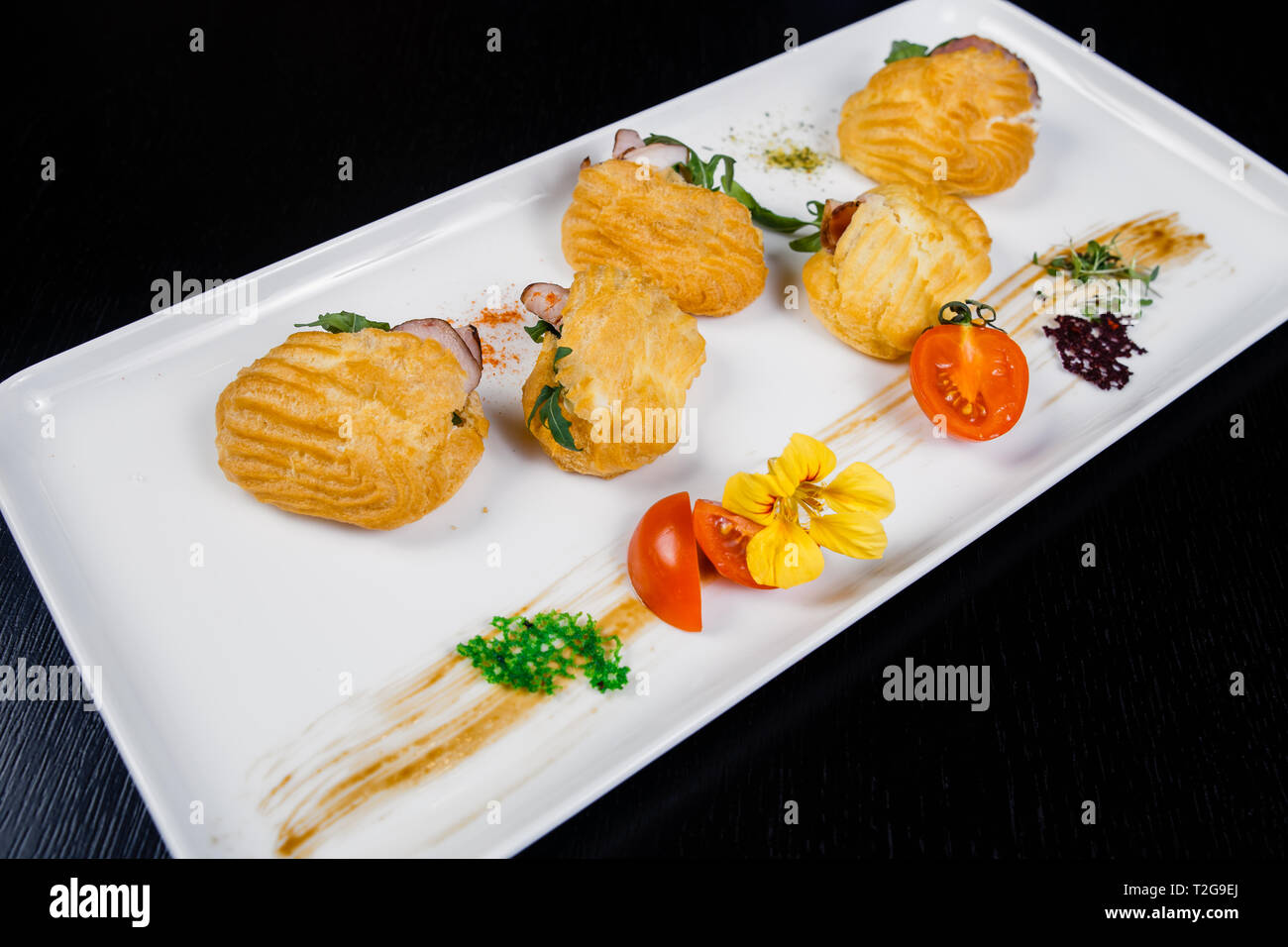 Mousse of cheese with bacon in eclair, served on a plate and covered ...