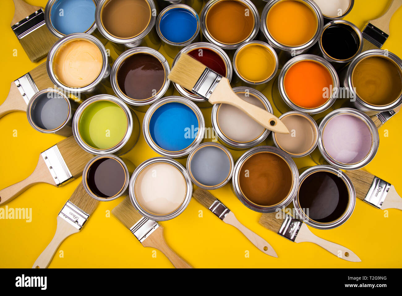 Metal tin cans with color paint and paintbrush Stock Photo - Alamy