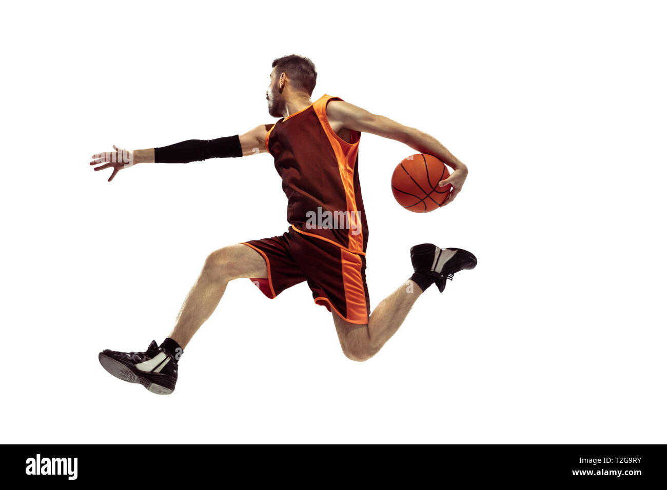 Full length portrait of a basketball player with ball isolated on white ...