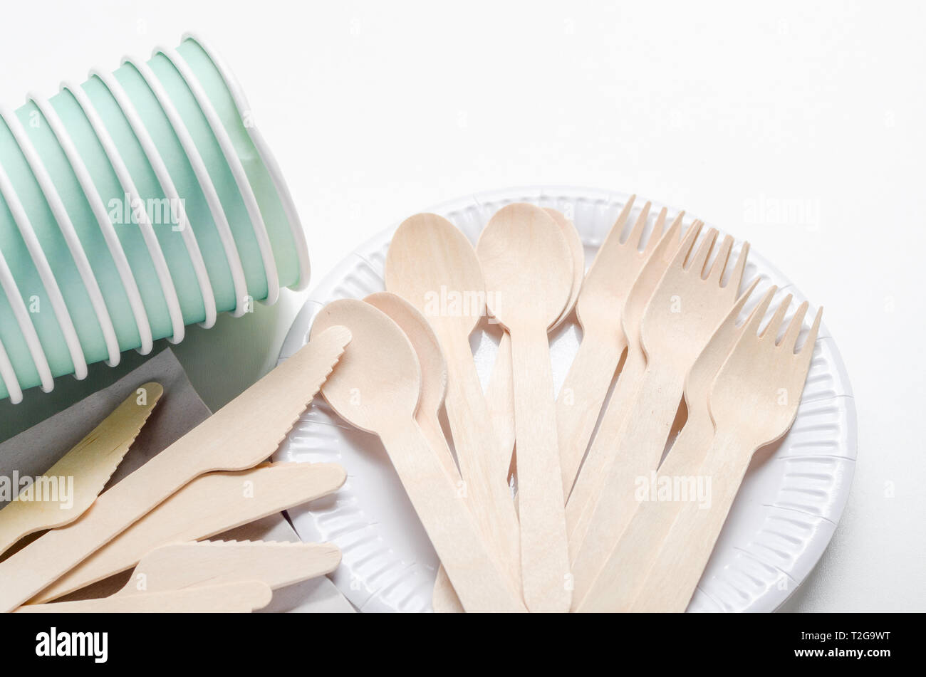 Wooden single use kitchenware and paper cups and plates on white Stock ...
