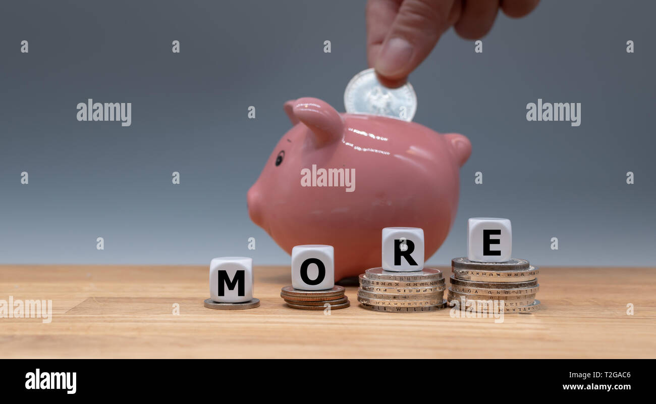 Symbol for getting more money. Dice placed on stacks of coins form the ...