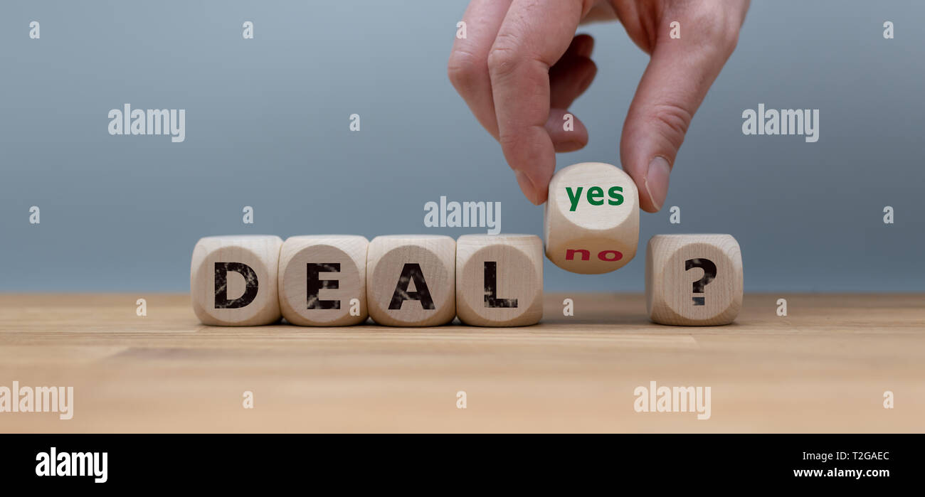 Deal or no deal? Hand turns a cube and changes the word "no" to "yes ...