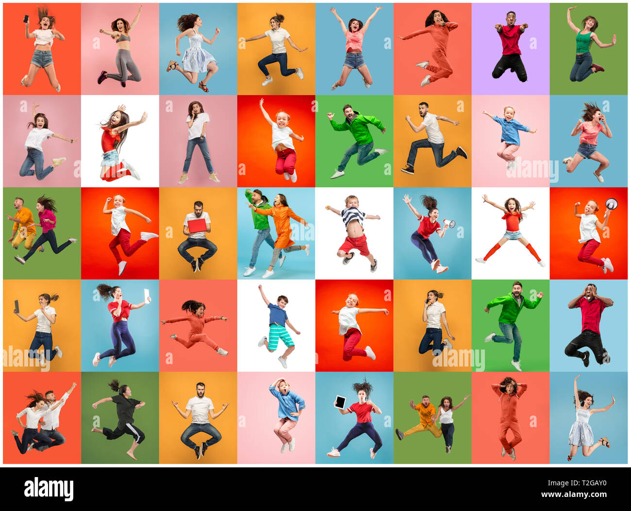 Freedom in moving. Happy young women and men jumping and gesturing ...