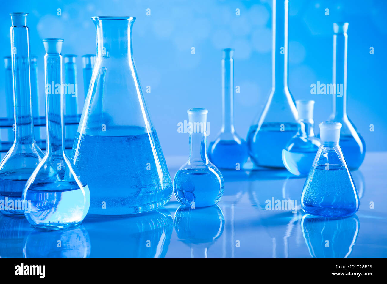Laboratory beakers,Science experiment, blue background Stock Photo - Alamy