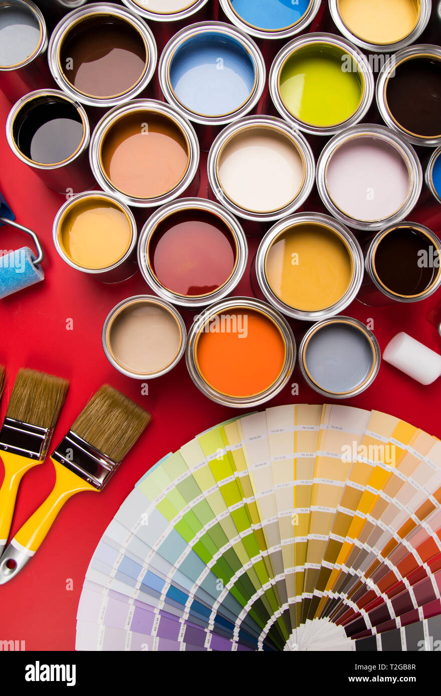 Full Buckets of rainbow colored oil paint on red background Stock Photo ...