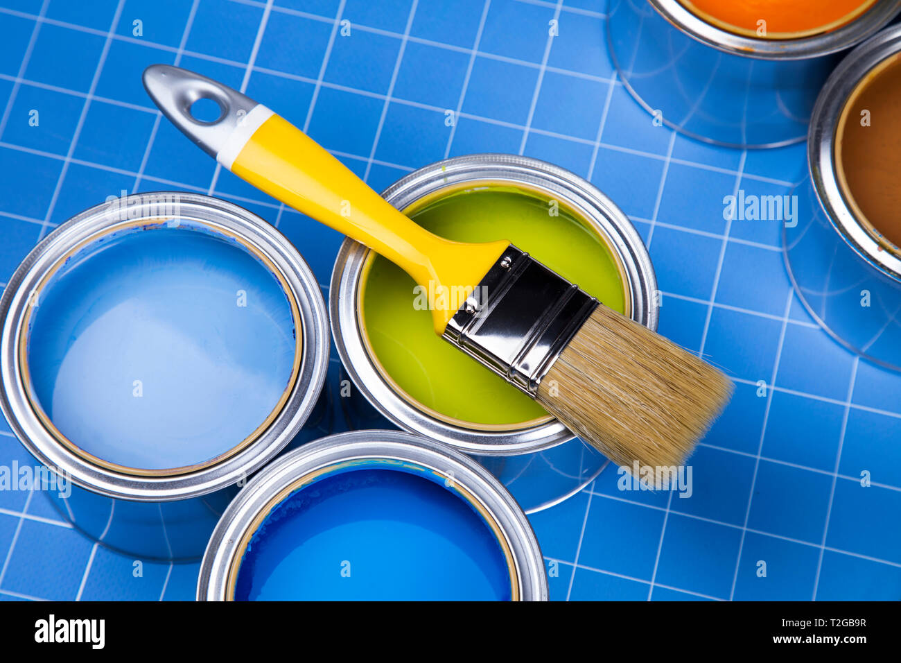 Paint brush, tin can and color guide samples, blue background Stock ...