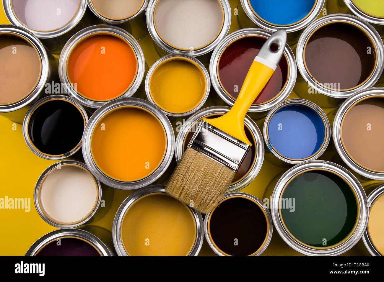Metal tin cans with color paint and paintbrush Stock Photo - Alamy