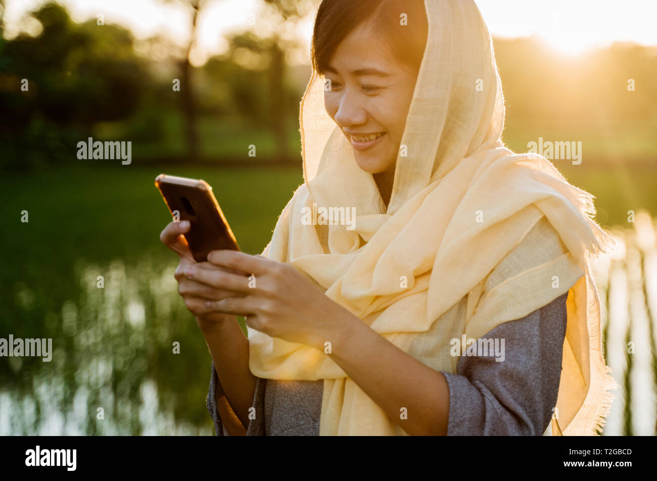 muslim woman with hijab using mobile phone outdoor Stock Photo - Alamy
