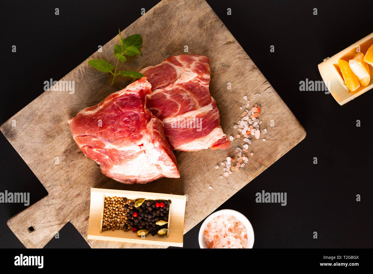 Food concept piece boneless Pork collar on cutting board with spice on ...