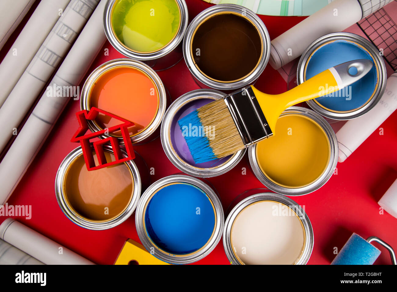 Open buckets with a paint and brush, red background Stock Photo - Alamy