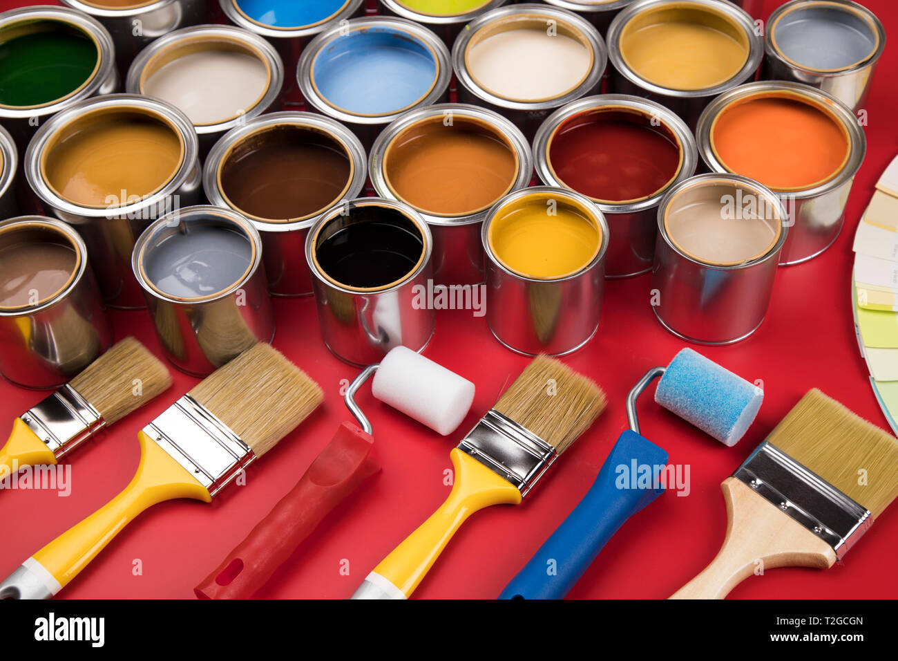Collection of colored paints cans, Brush, red background Stock Photo ...