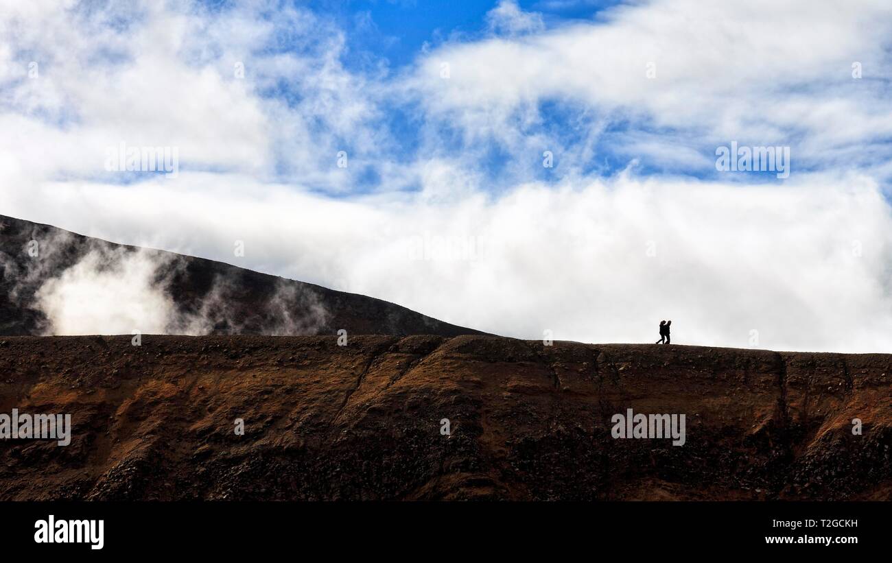Two hikers at the crater rim as silhouettes, Viti crater, volcanic area ...
