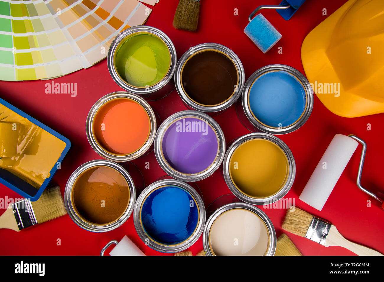 Collection of colored paints cans, Brush, red background Stock Photo ...