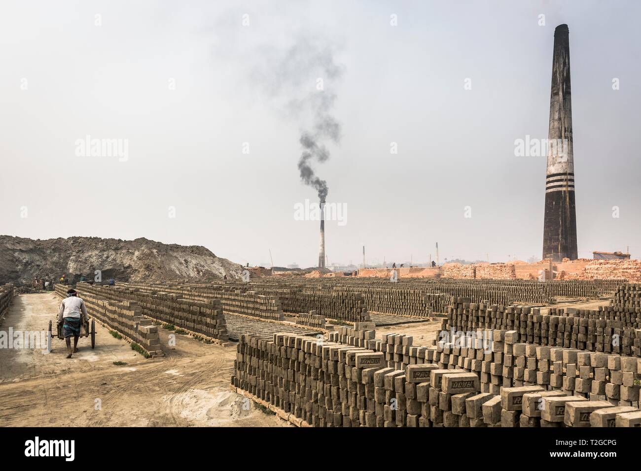 Stack of bricks with burning towers in a brickyard, Dhaka, Bangladesh ...