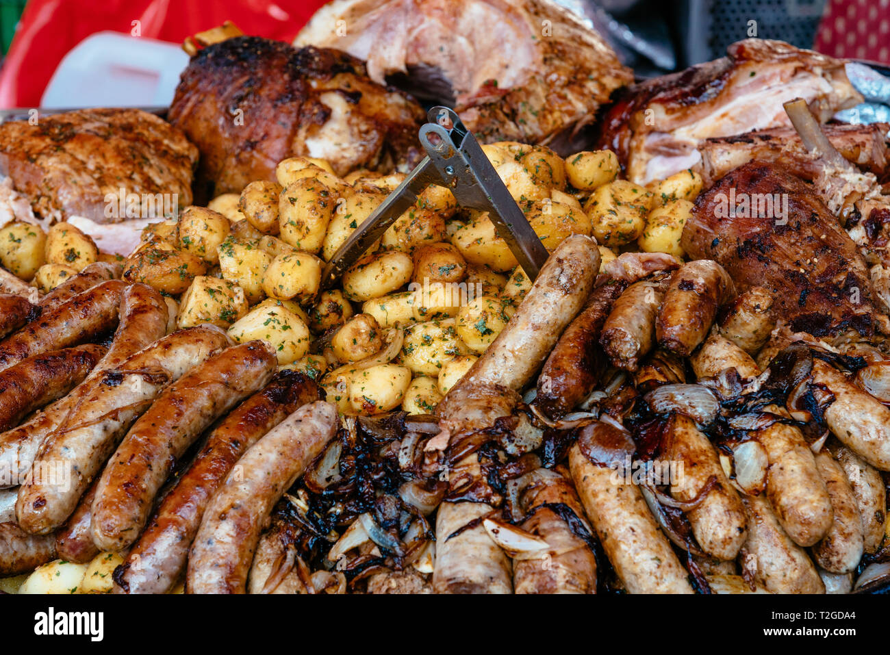 Sausages and meat greasy with onions and potatoes in food market Stock ...