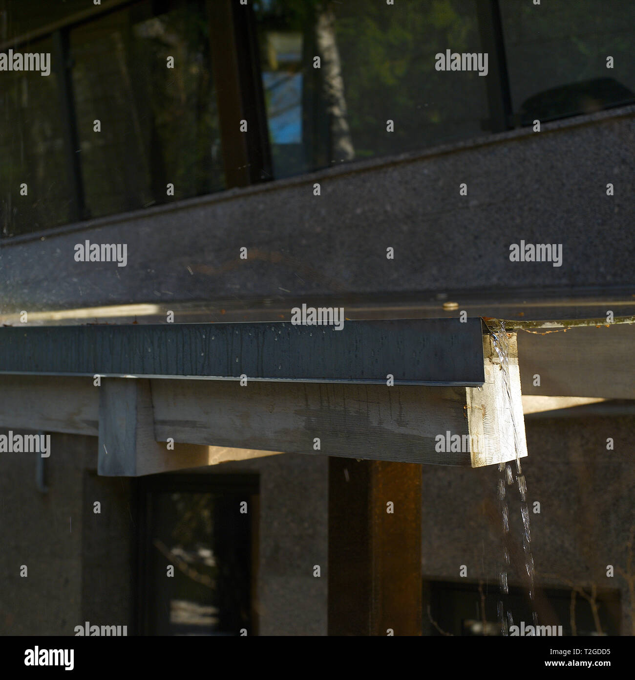 A water running from a roof drain after rain, square outdoor closeup ...