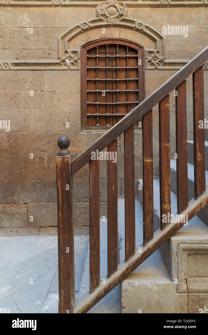 Wooden window and staircase with wooden balustrade leading to historic ...