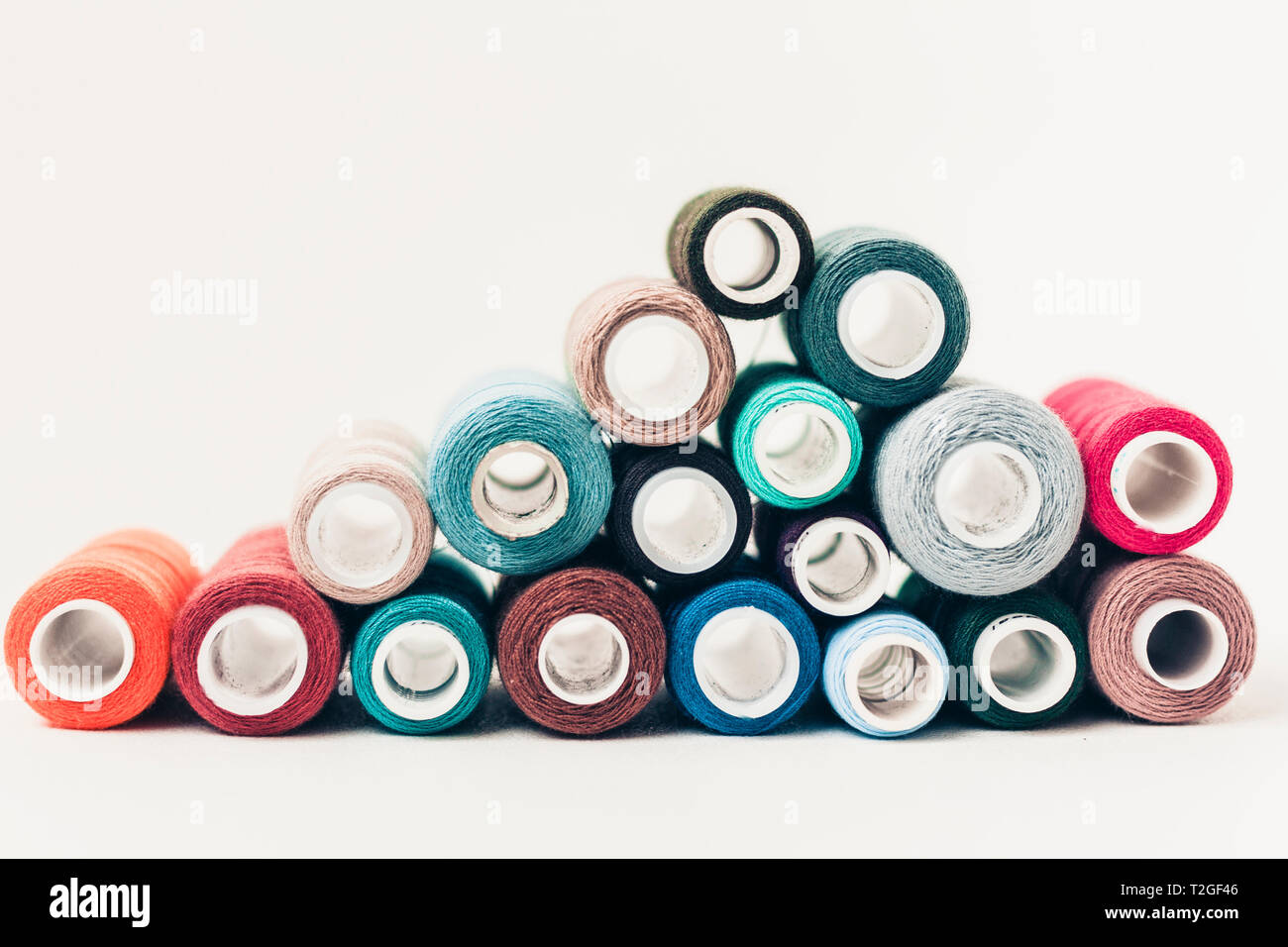 Colored sewing thread coils on white background with copy space for ...