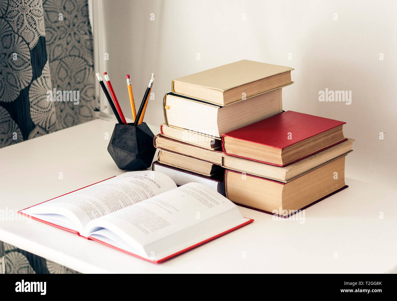 Stack of old books, textbook and pencils in office background for ...