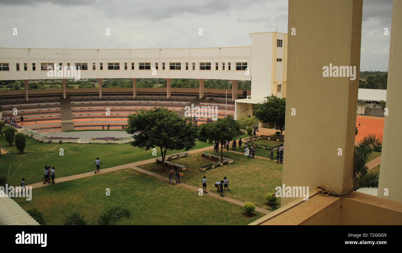 A school with bridge, school gardens, school amphitheatre with children ...