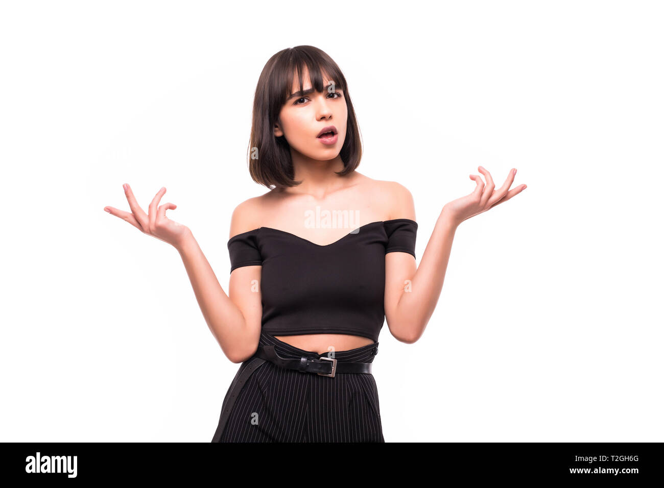 Portrait of a pretty woman shrugging shoulders on a white background ...