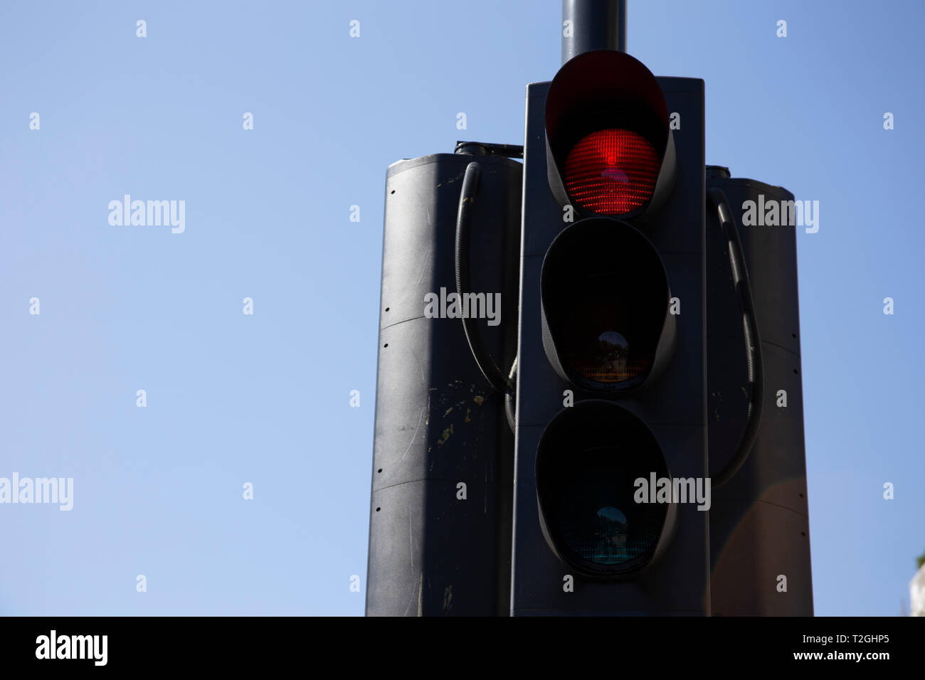 Red traffic light against a blue sky Stock Photo - Alamy