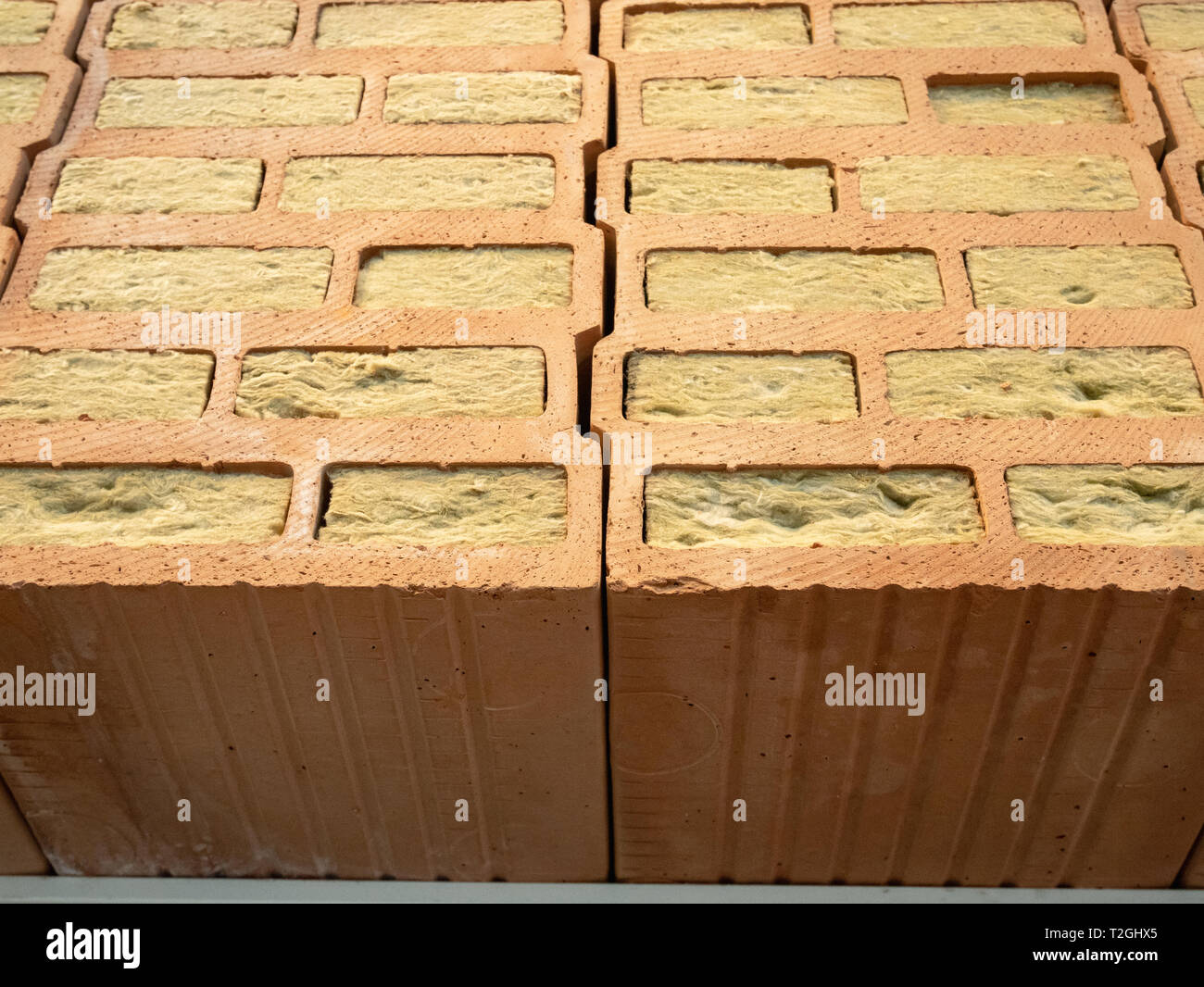 side view on masonry hollow red bricks with modern material - mineral ...