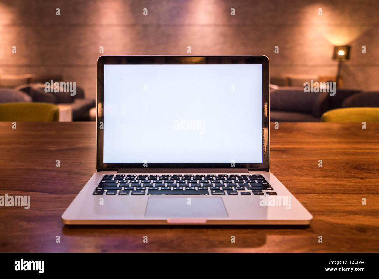Conceptual workspace, Laptop computer with blank white screen on table ...