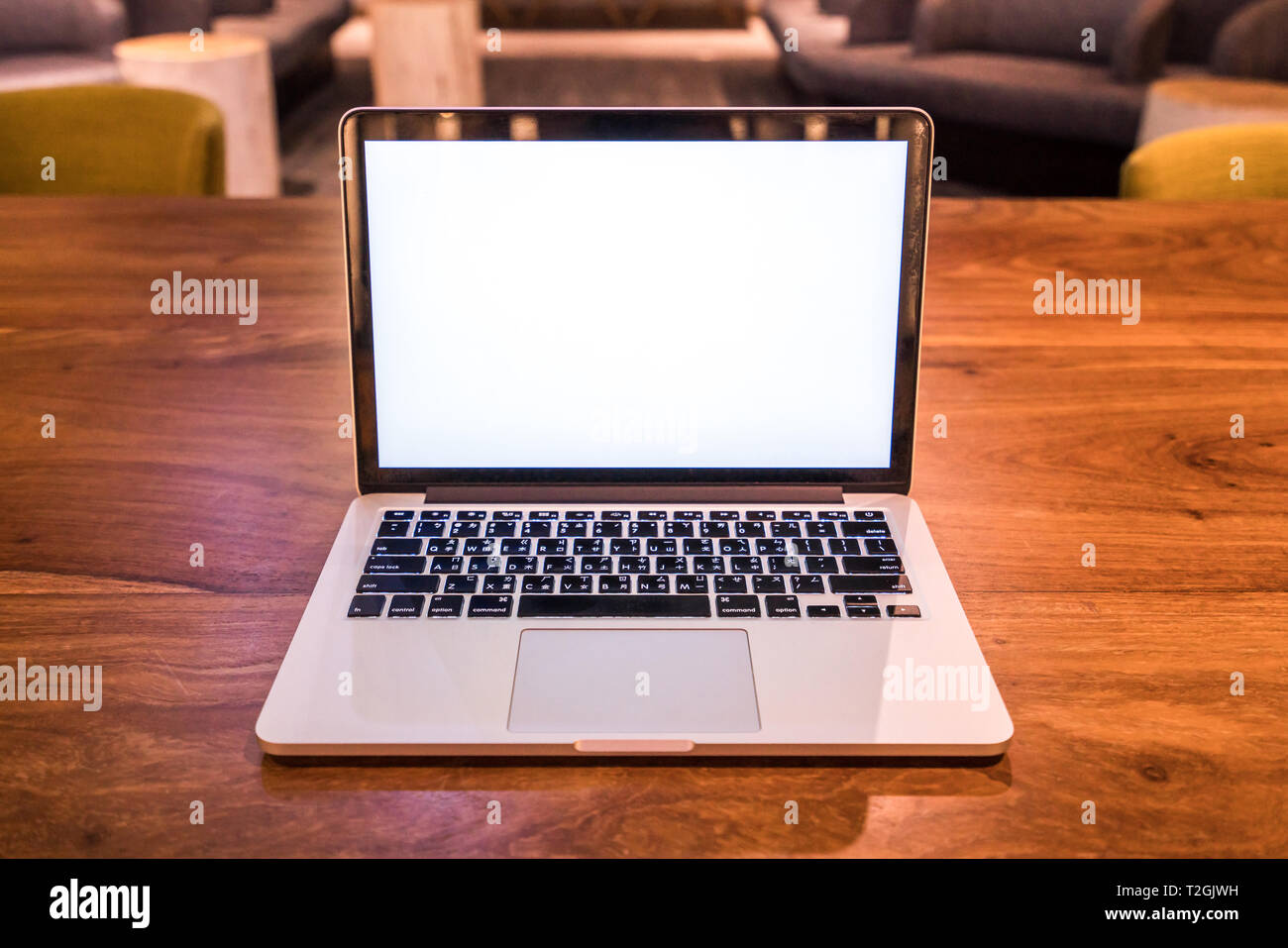 Conceptual workspace, Laptop computer with blank white screen on table ...