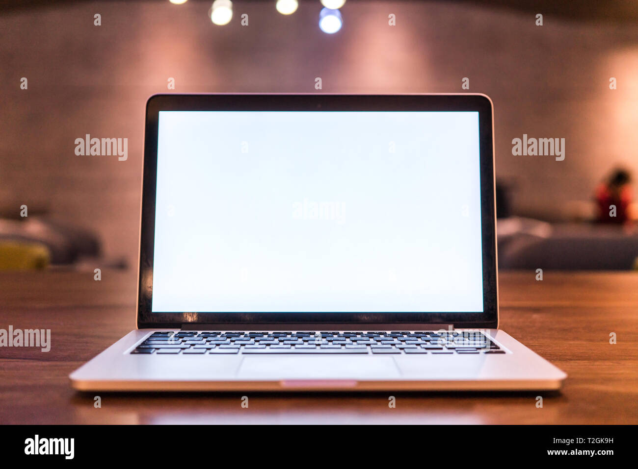 Conceptual workspace, Laptop computer with blank white screen on table ...