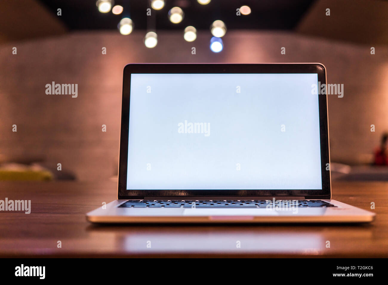 Conceptual workspace, Laptop computer with blank white screen on table ...