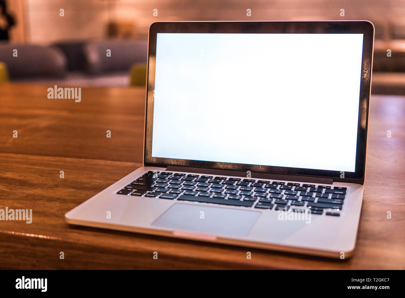 Conceptual workspace, Laptop computer with blank white screen on table ...