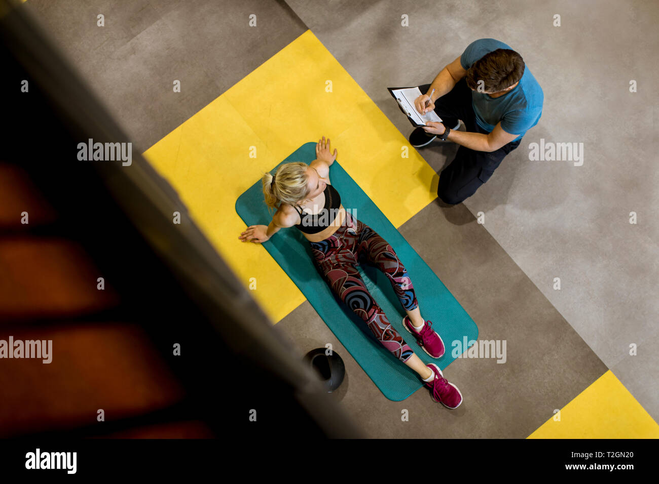 Top view at sporty woman doing exercises with assistance of her ...