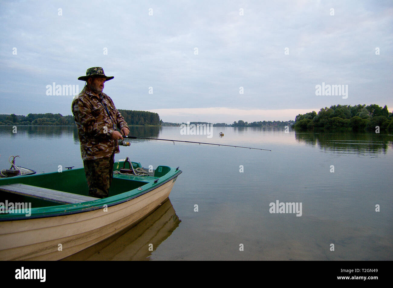 Old Angler on a boat Stock Photo - Alamy