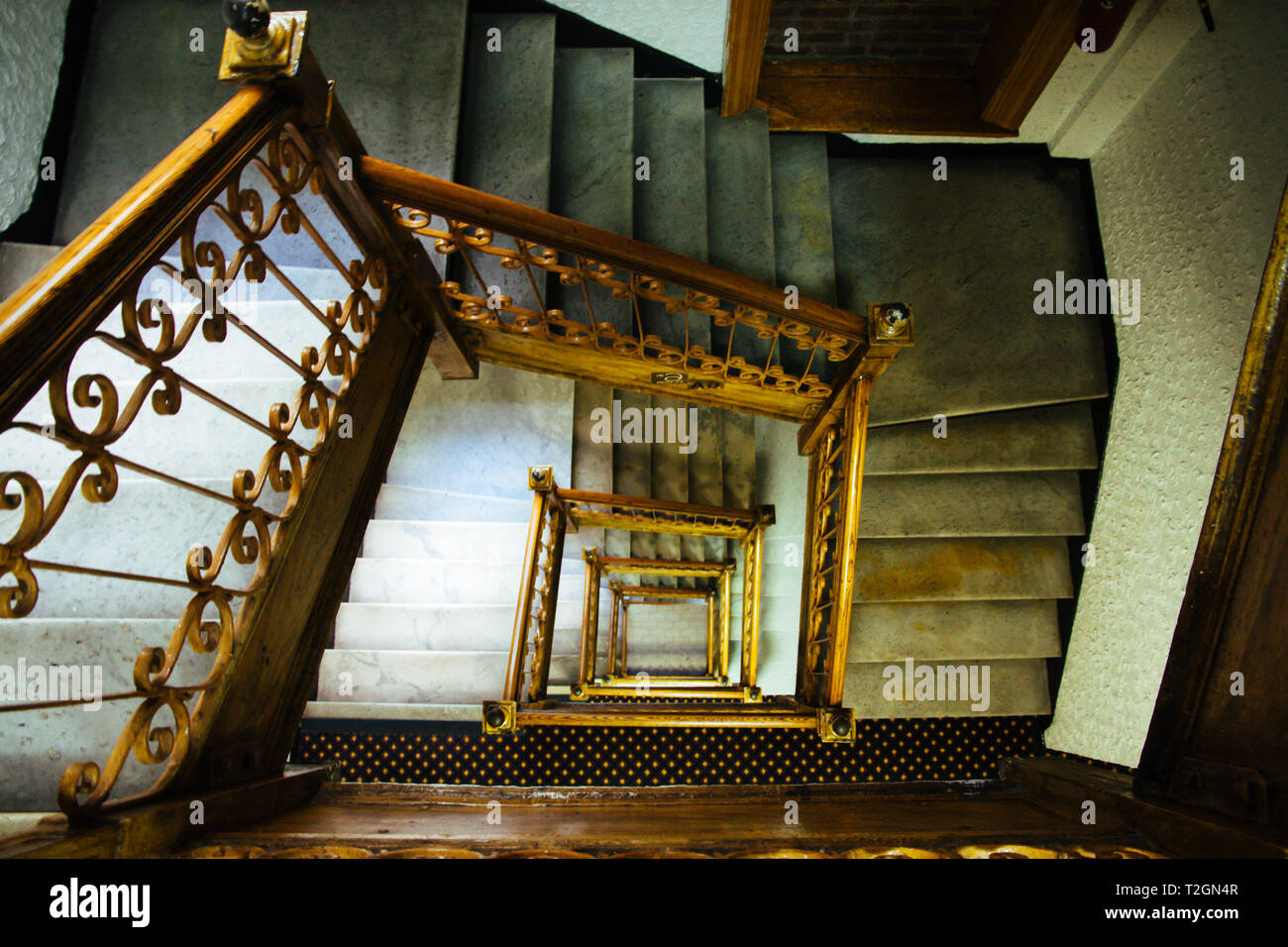 Old vintage squared spiral multi-flight stairs stairway with brown wood ...