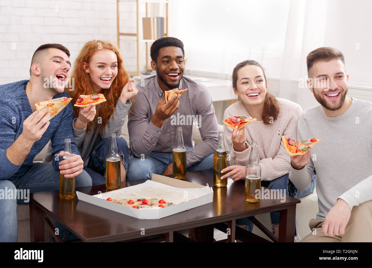 Friends eating pizza and watching comedy film at home Stock Photo - Alamy