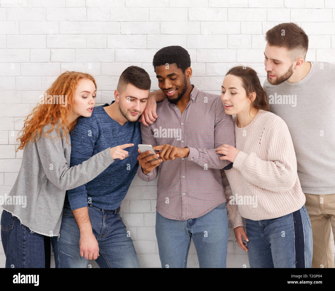 Man showing video on phone to friends, spending time together, white ...
