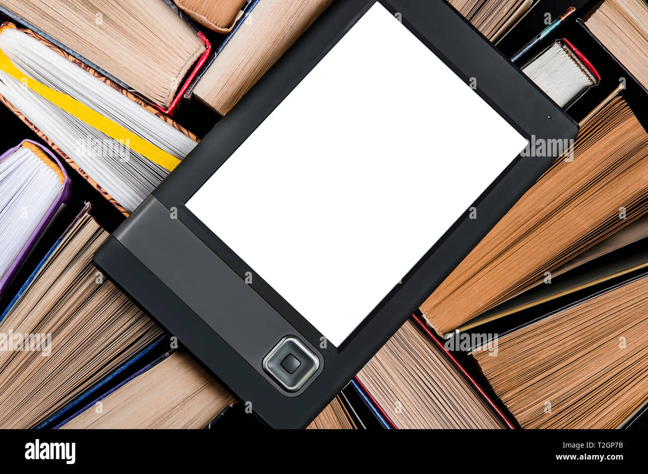 The e-book with a white screen lies on the open multi-colored books ...