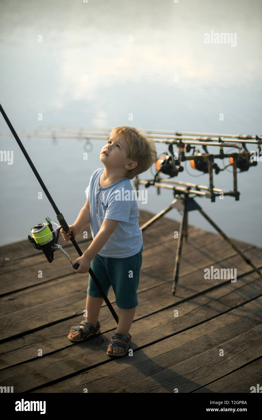 Child with fishing rod on wooden pier. Fishing, angling, activity ...