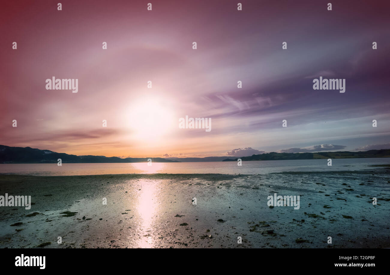 Colorful sunset with halo optical effect over the sun. The picture ...
