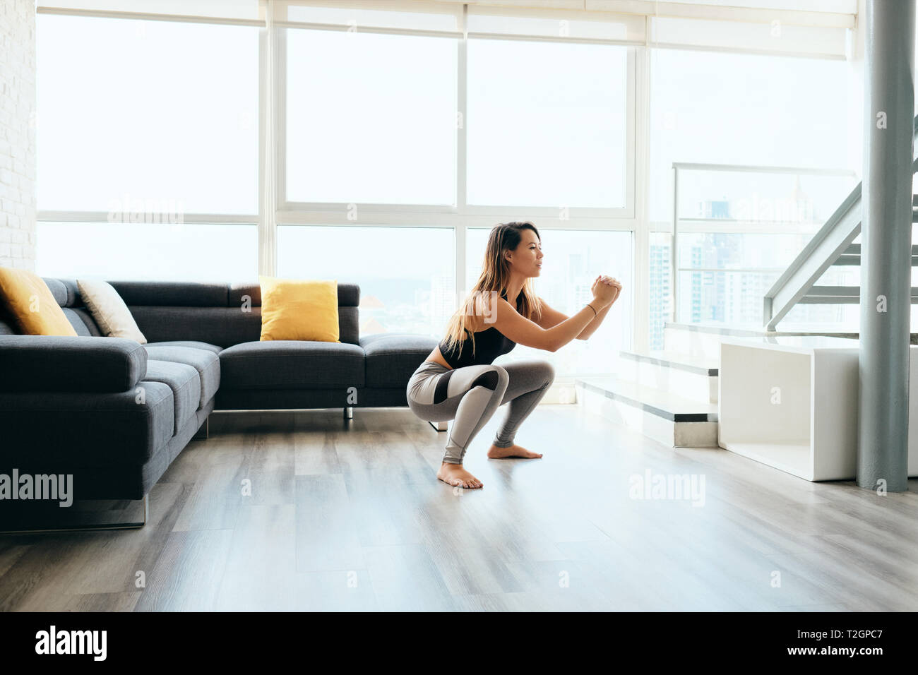 Fit young Pacific Islander woman training at home. Beautiful female ...