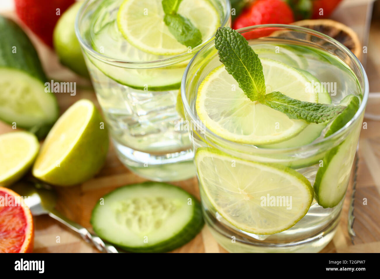 Lime with cucumber punch home made cocktail closeup on wood background ...