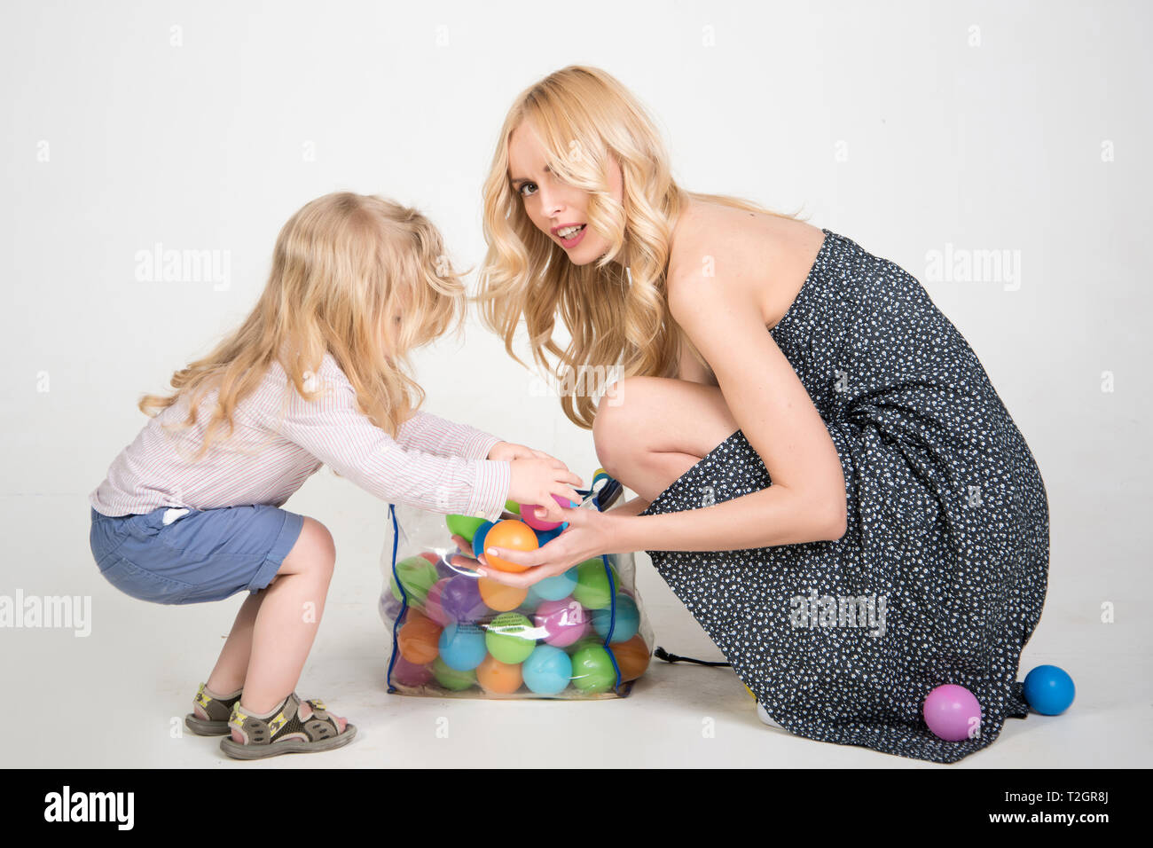 mother and child, relatives. Happy family play with toy balls. Mothers ...