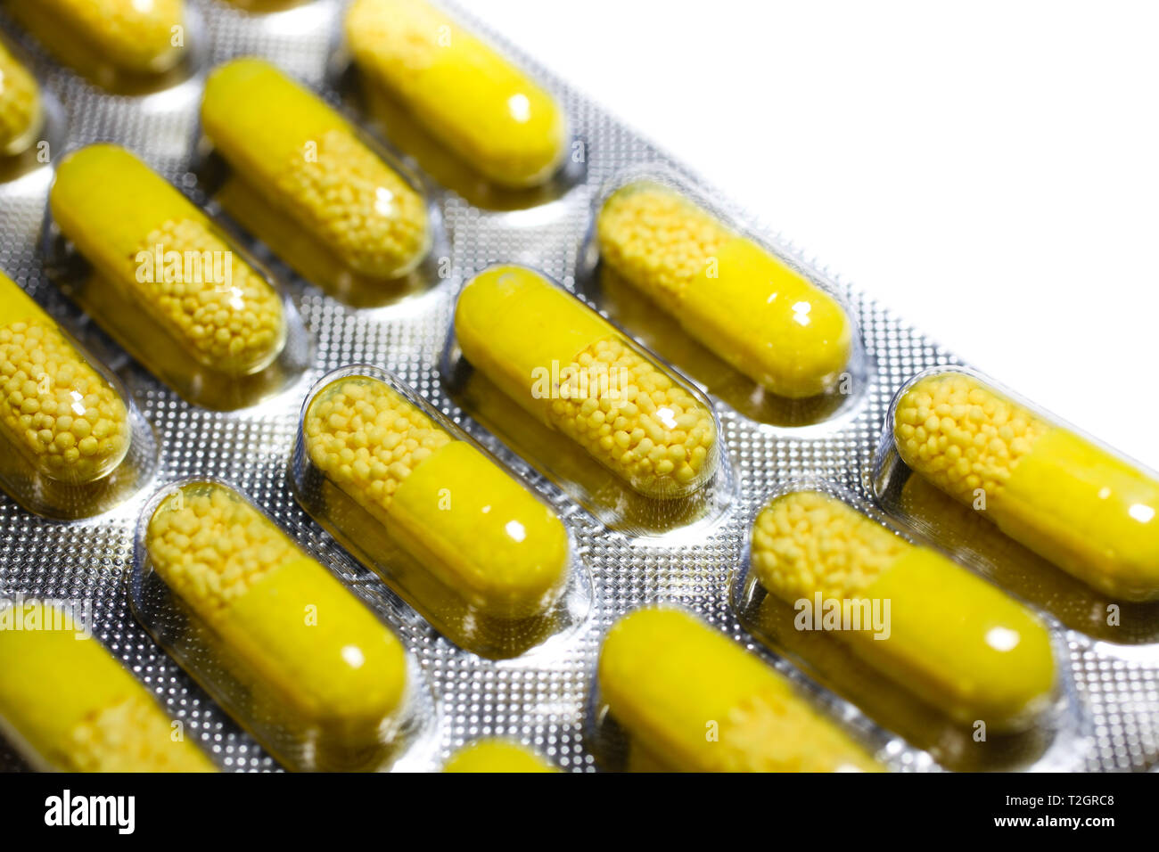 Yellow capsules with yellow granules medicine in gray tablet pill ...