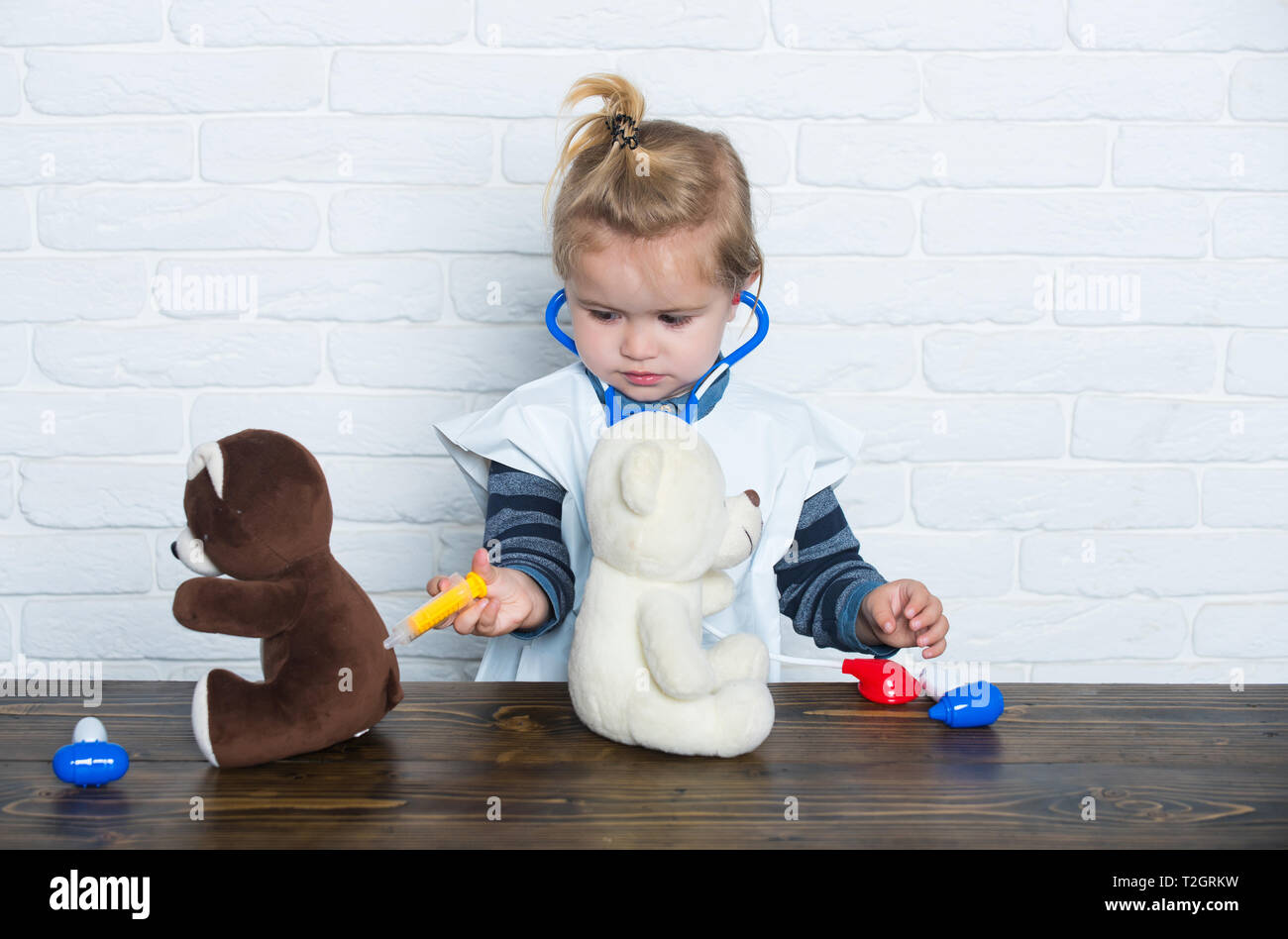 Boy doctor make injection to teddy bears with syringe. Child ...