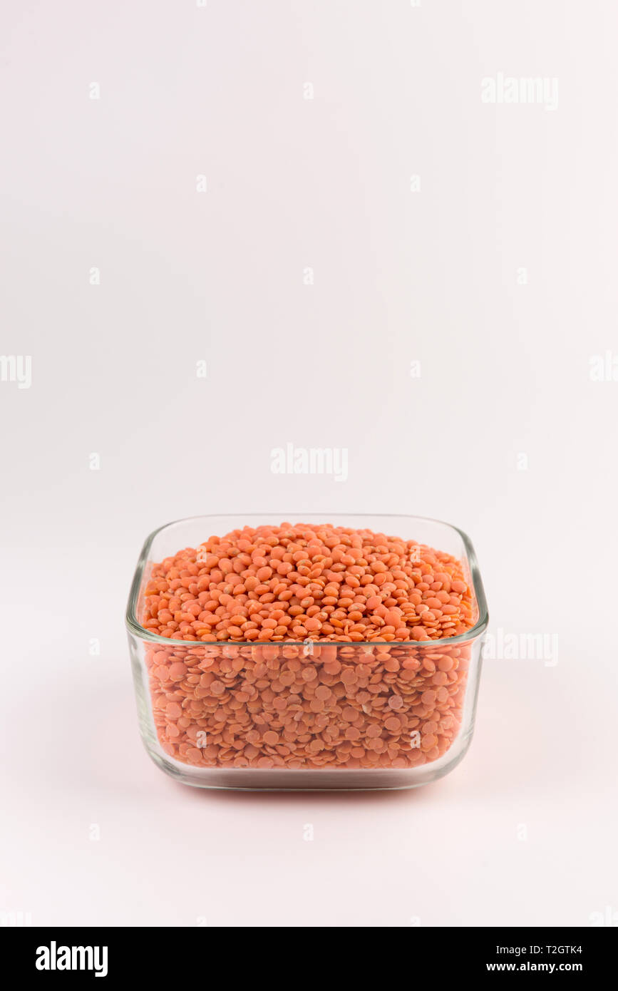 Red lentils in glass plate isolated on white background Stock Photo - Alamy